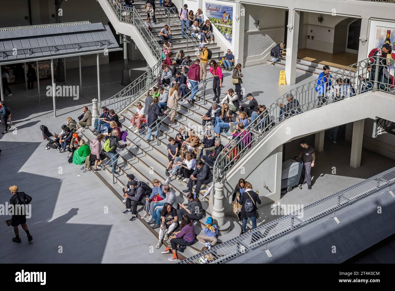 Crowd of young people sitting on the stairs in the Bolhao Market eating ...