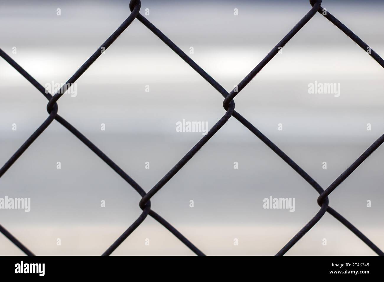 Metal mesh on the background of the road close up Stock Photo - Alamy