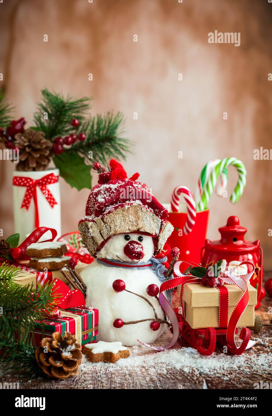 Snowman, Christmas presents and sweets over wooden background Stock ...