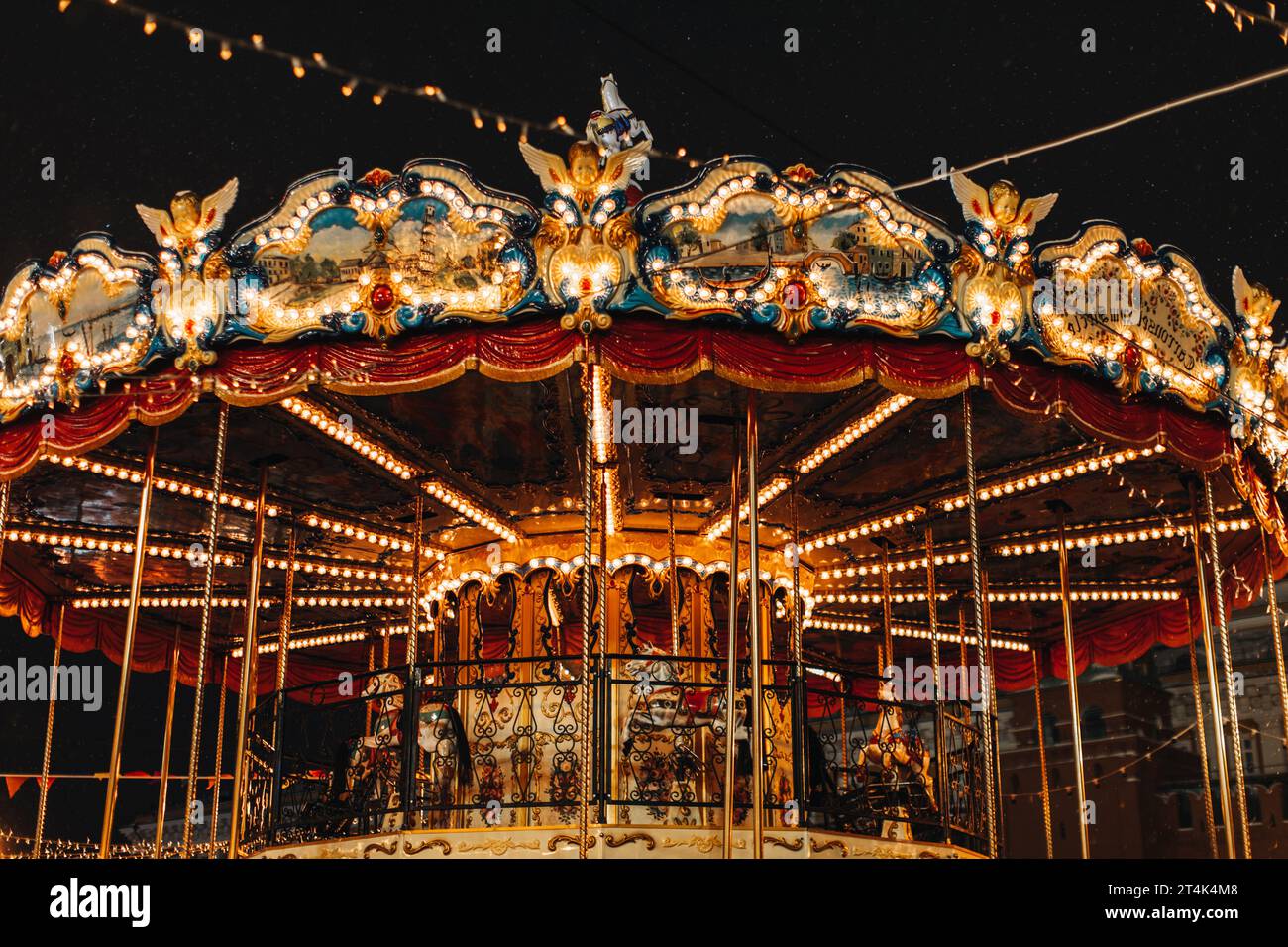 Golden children's magic vintage carousel with horses Merry-go-round in the evening lights Stock ...