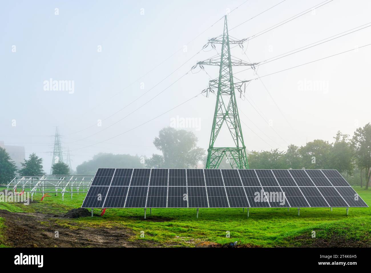 Construction of new solar power plant panels near high voltage power ...