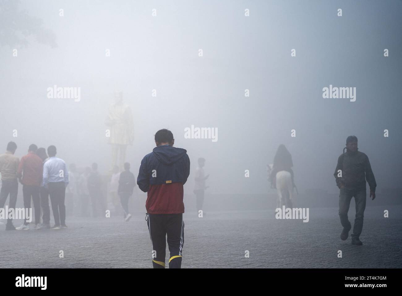 crowd of men women walking in thick fog with cobbled stones and a horse ...