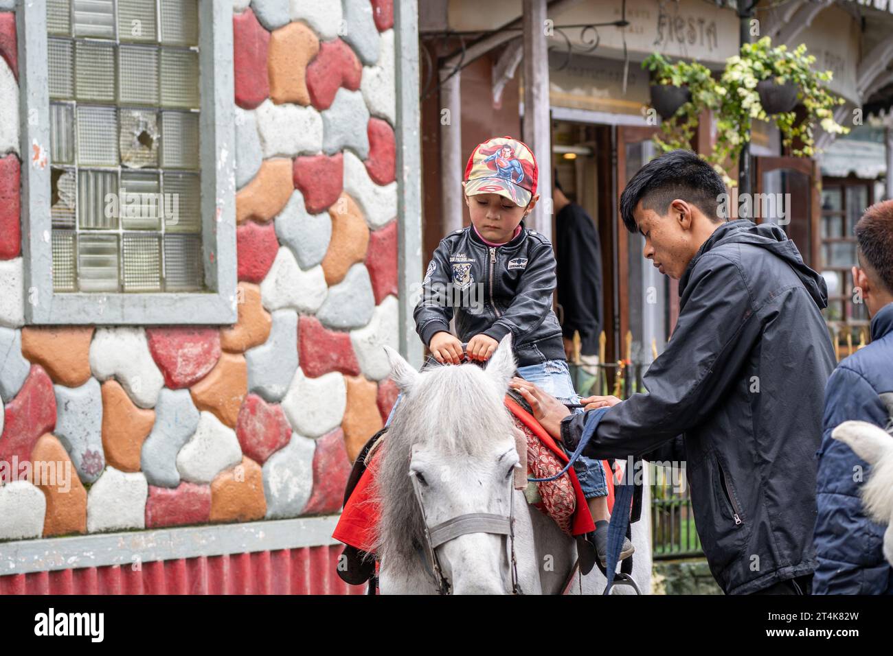 Young child riding a pony a common tourist attraction on mall roads in ...