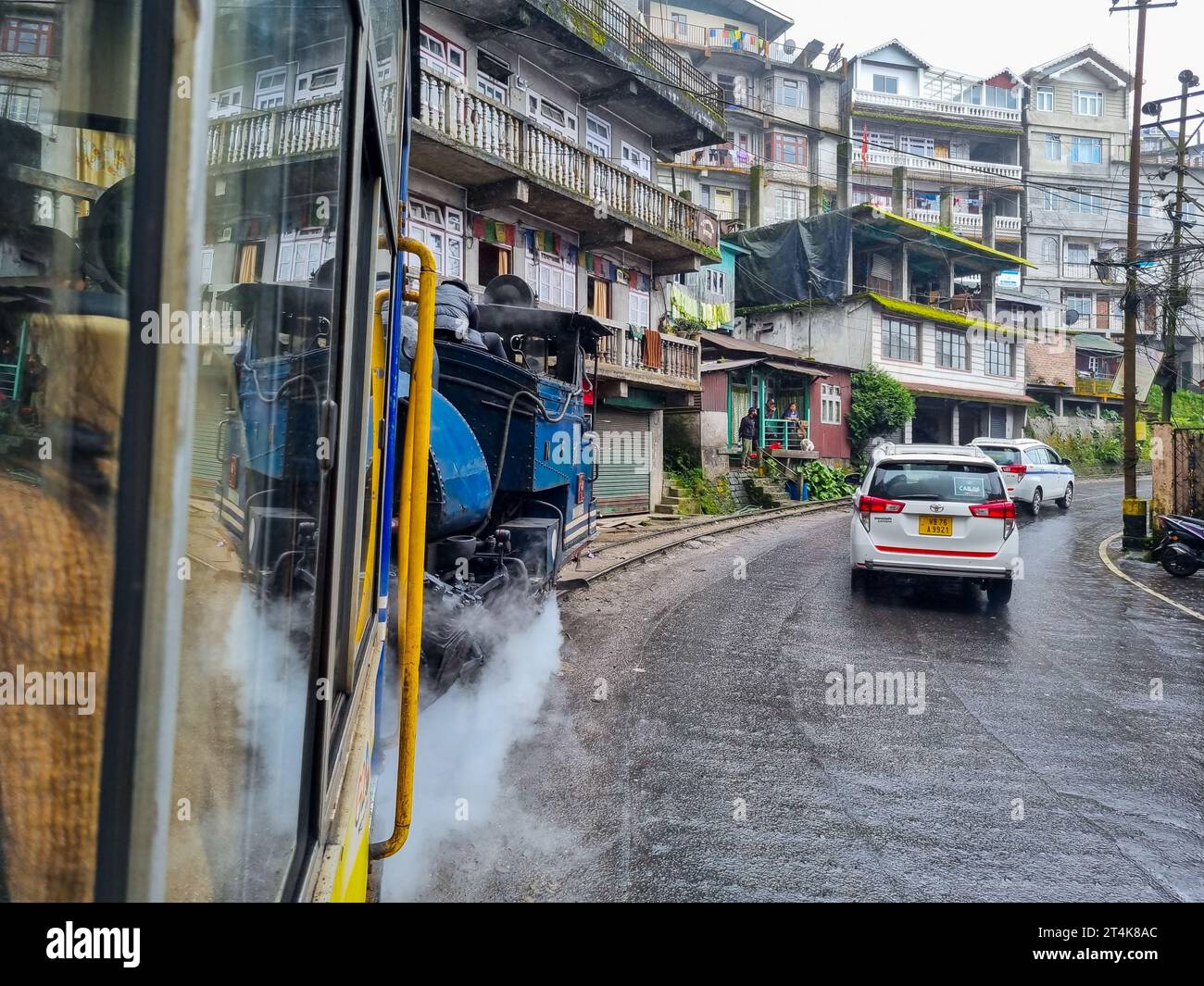 view outside toy train in darjeeling shimla showing the wet street and ...