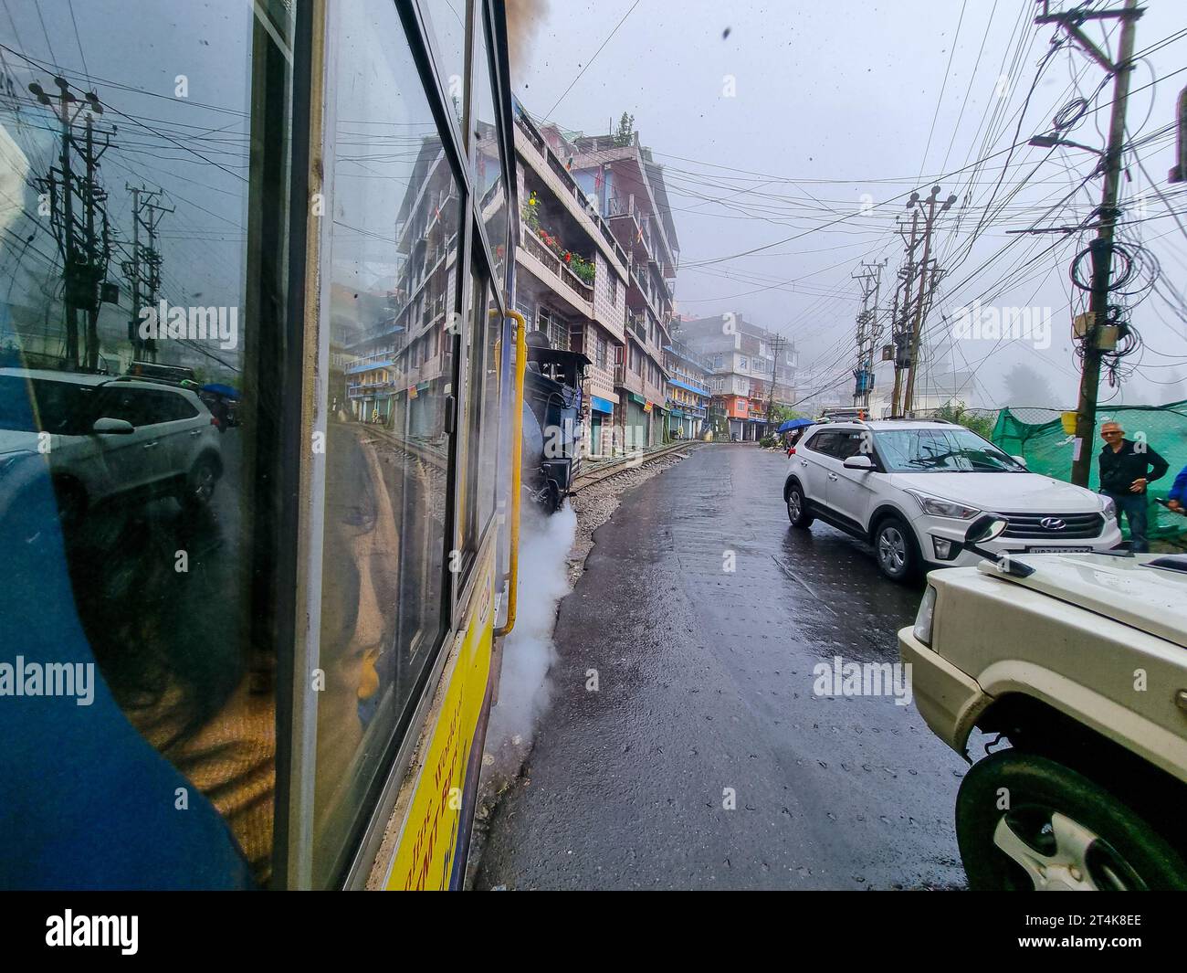 view outside toy train in darjeeling shimla showing the wet street and ...