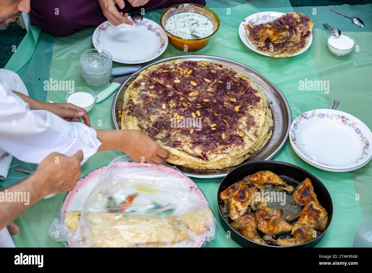 Family and friends gathering together at home for eating palestinian ...