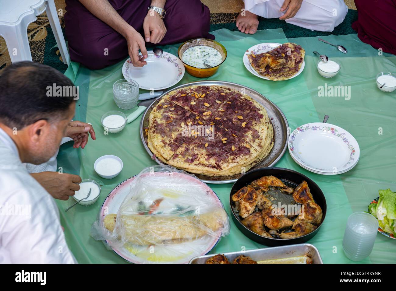 Family and friends gathering together at home for eating palestinian ...