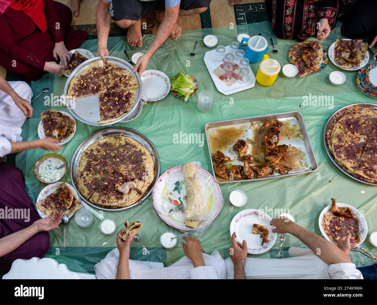 Family and friends gathering together at home for eating musakhan and ...