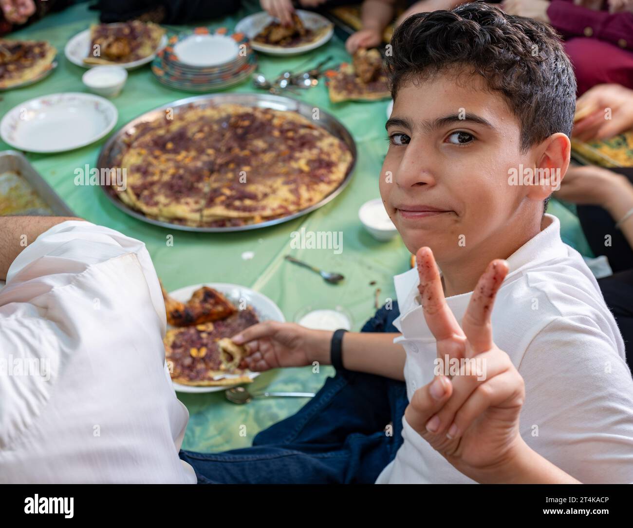 Portrait Of boy making vector gesture or two number with hand while ...