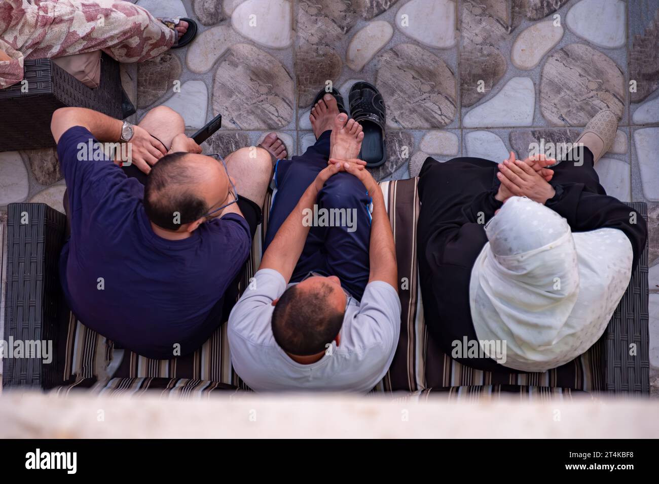 Group of brothers sitting near each other with smile on their faces ...