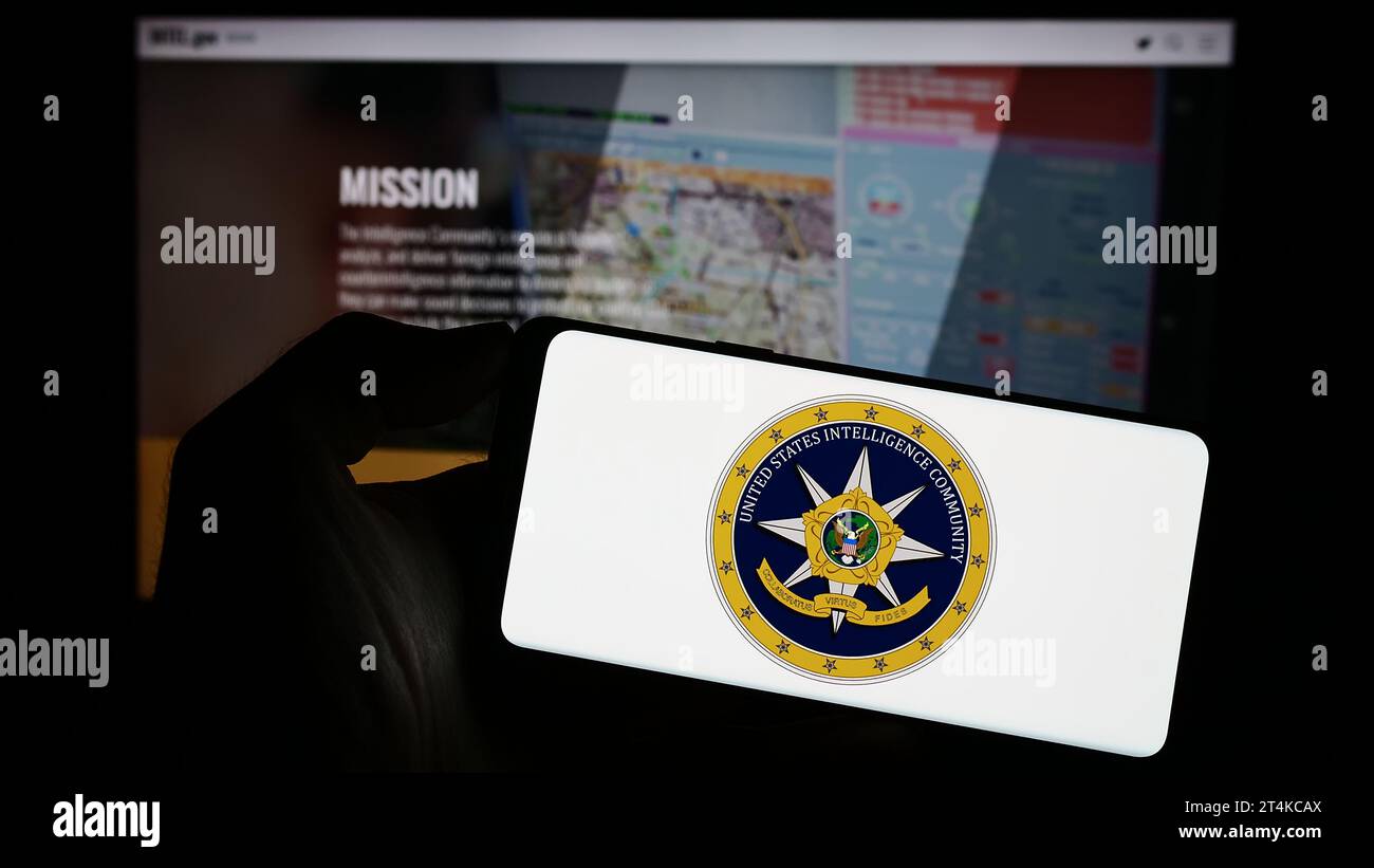 Person holding mobile phone with seal of agency group United States ...