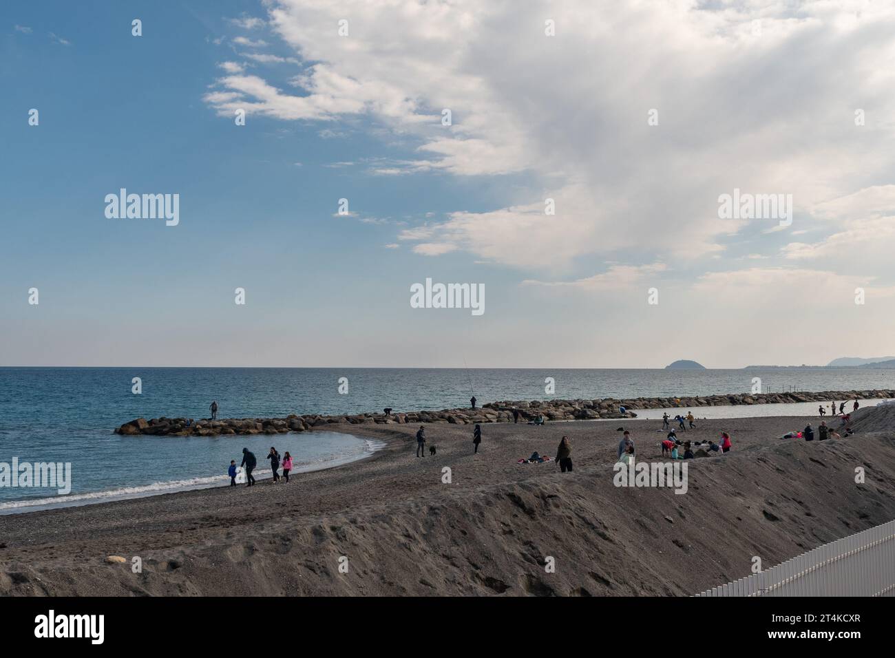 People on the beach of the popular holiday destination, with the ...