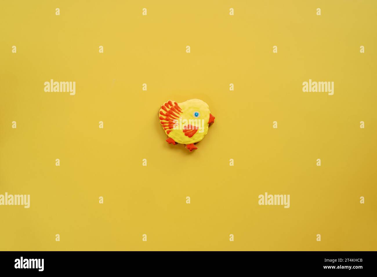 Glazed yellow gingerbread chicken lies on a yellow background Stock ...