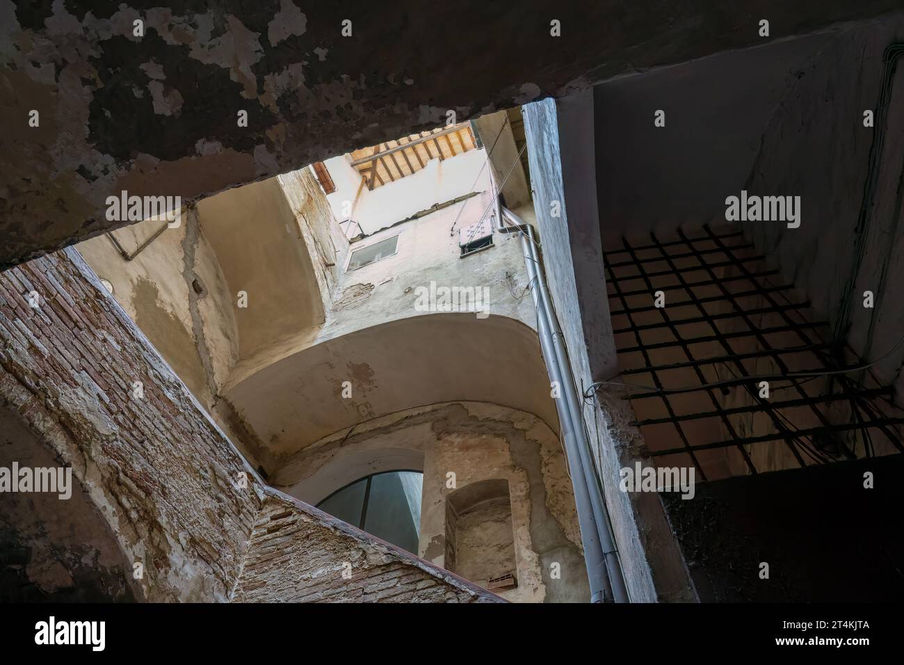 a stair well of a courtyard inside an Italian town building Stock Photo ...