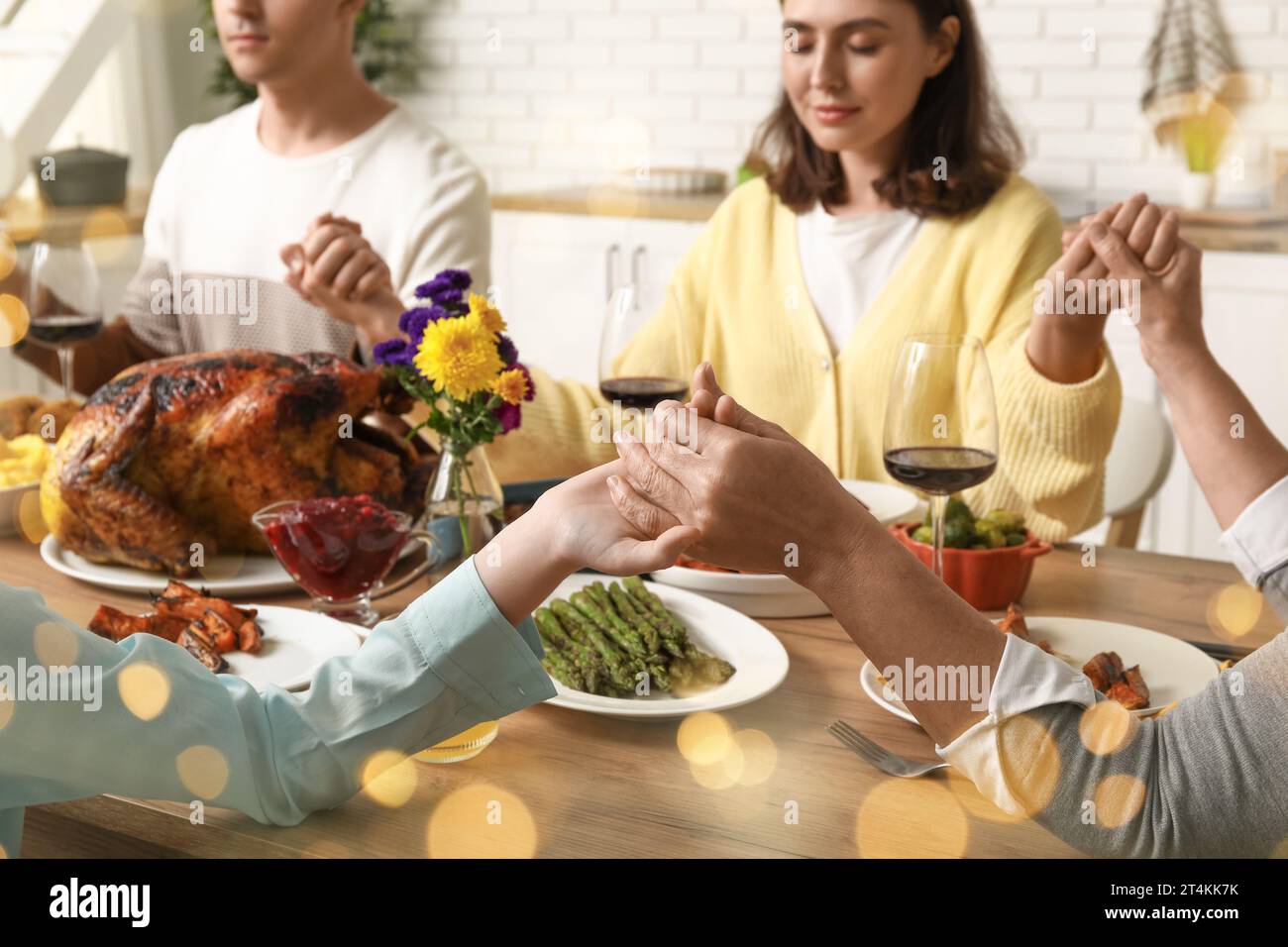 Happy family praying before dinner on Thanksgiving Day Stock Photo - Alamy