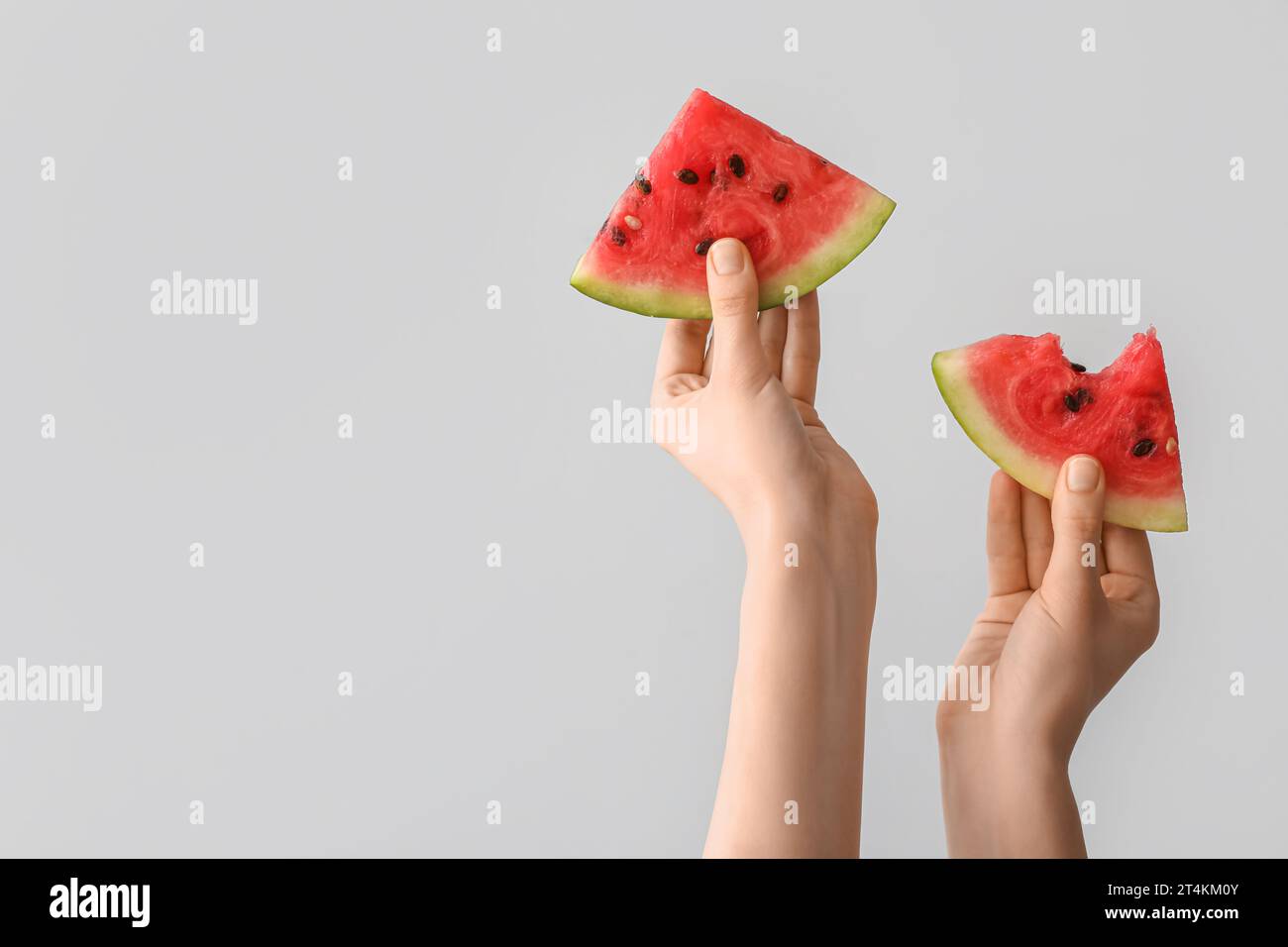 Female hands with slices of ripe watermelon on white background Stock ...