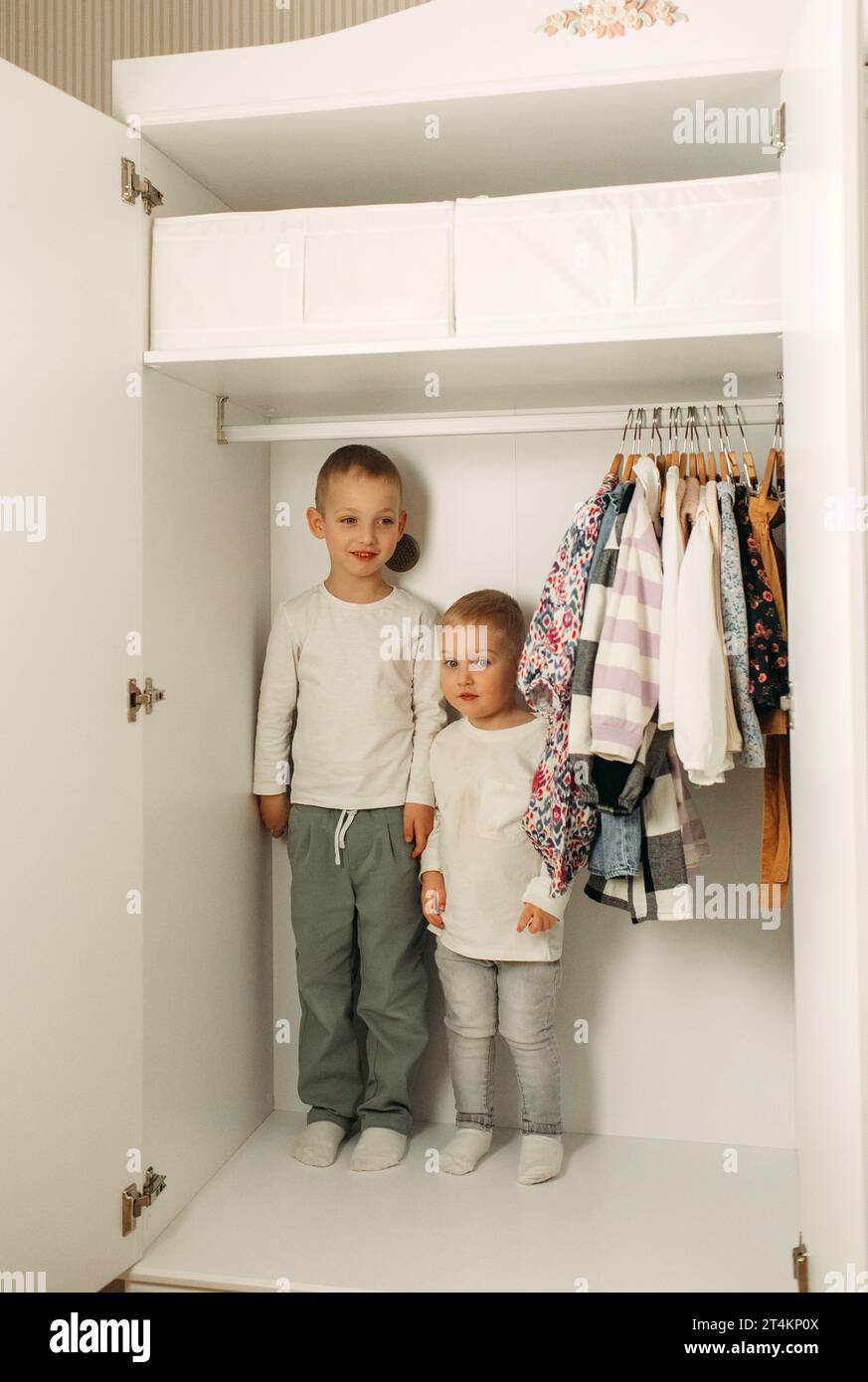 Children hiding in wardrobe hi-res stock photography and images - Alamy