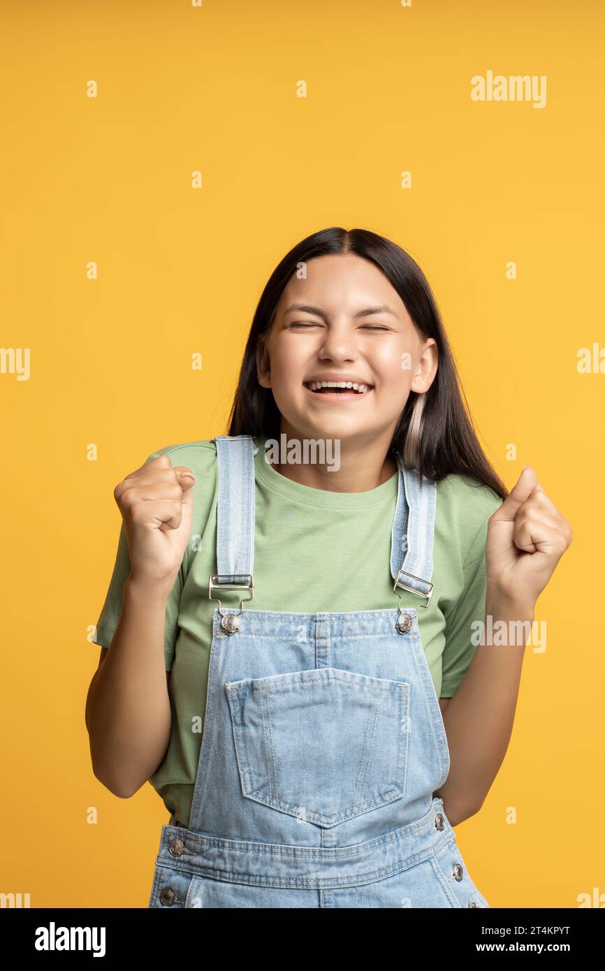 Portrait happy teen girl rejoicing smiling with closed eyes clenching ...