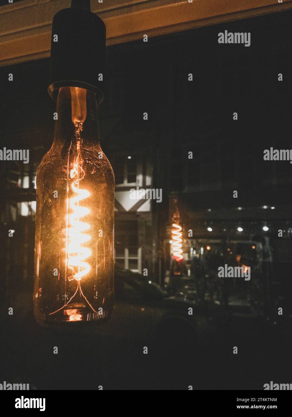 light bulb illuminating a dark room with reflection on window Stock ...