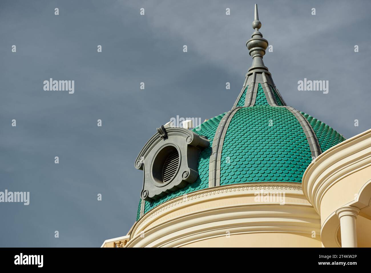 the facade of a famous building in Monaco with a picturesque green dome ...