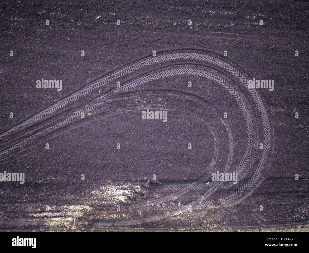 Tractor trace on fresh ploughed field. Top down aerial photo from drone ...