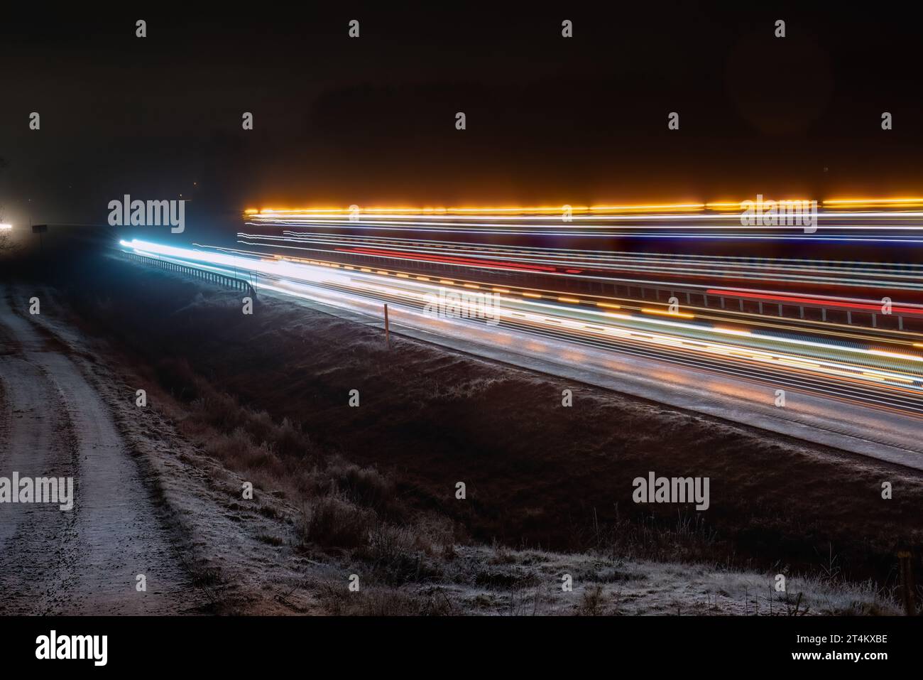 Scenic intensive traffic light trails on motorway in total night ...