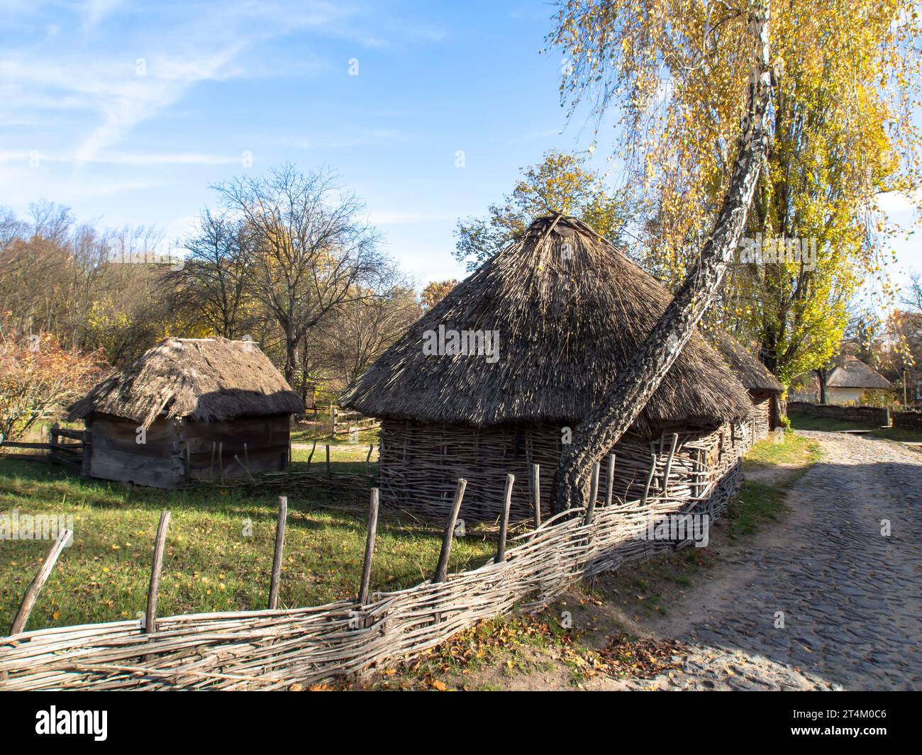 Traditional wooden homes with thatched roof in Ukraine. National Museum ...