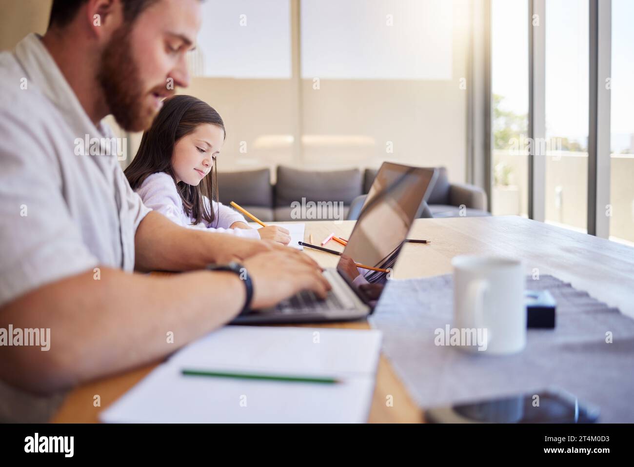 Father working from home on his laptop. Freelancer dad using laptop ...