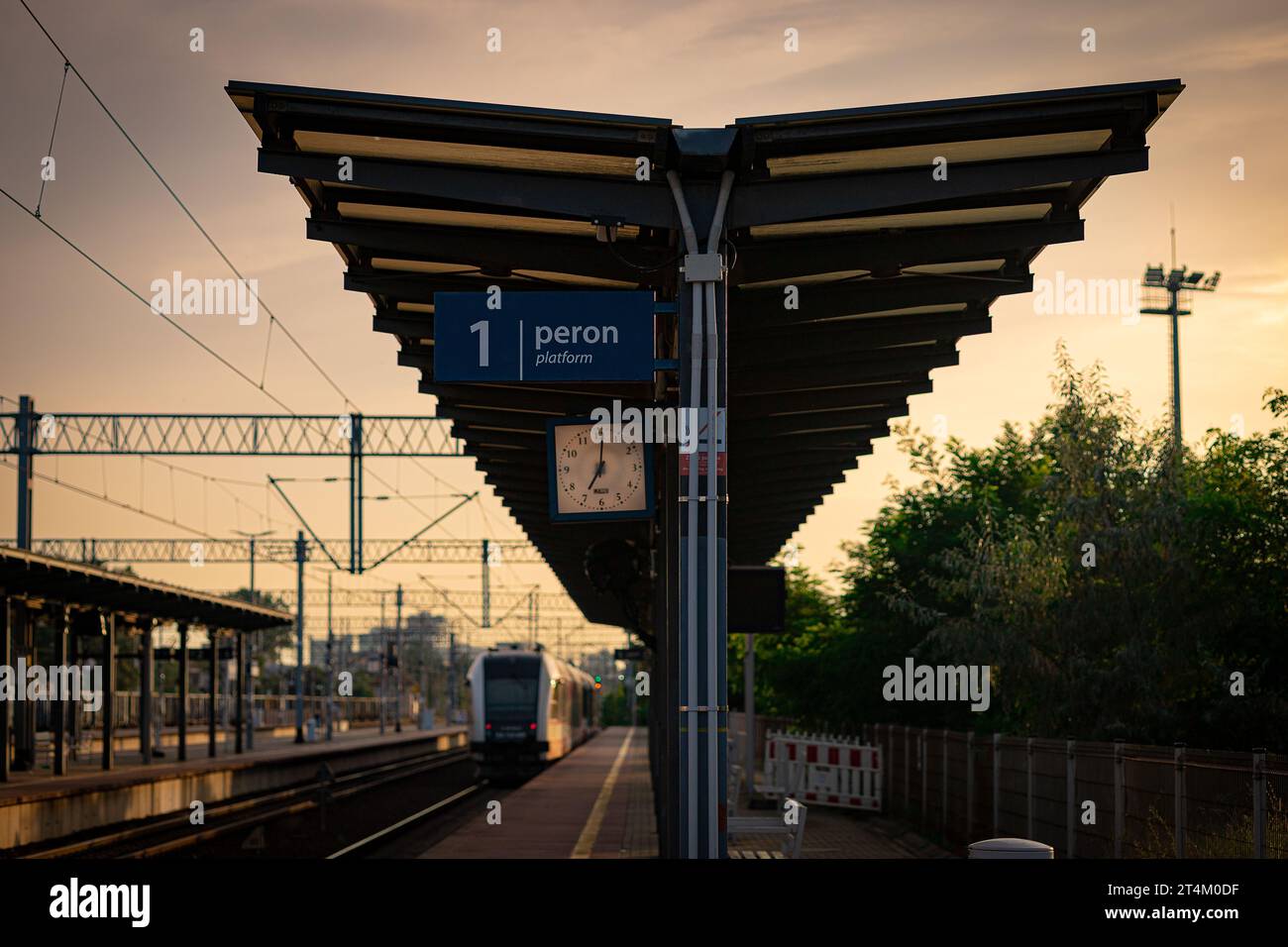A railway station platform with a train standing still upon it Stock ...