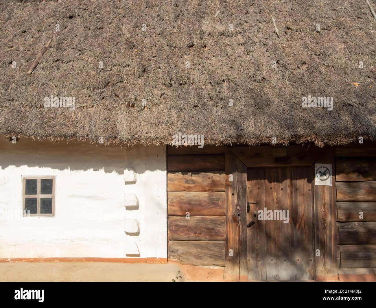 Traditional wooden homes with thatched roof in Ukraine. National Museum ...