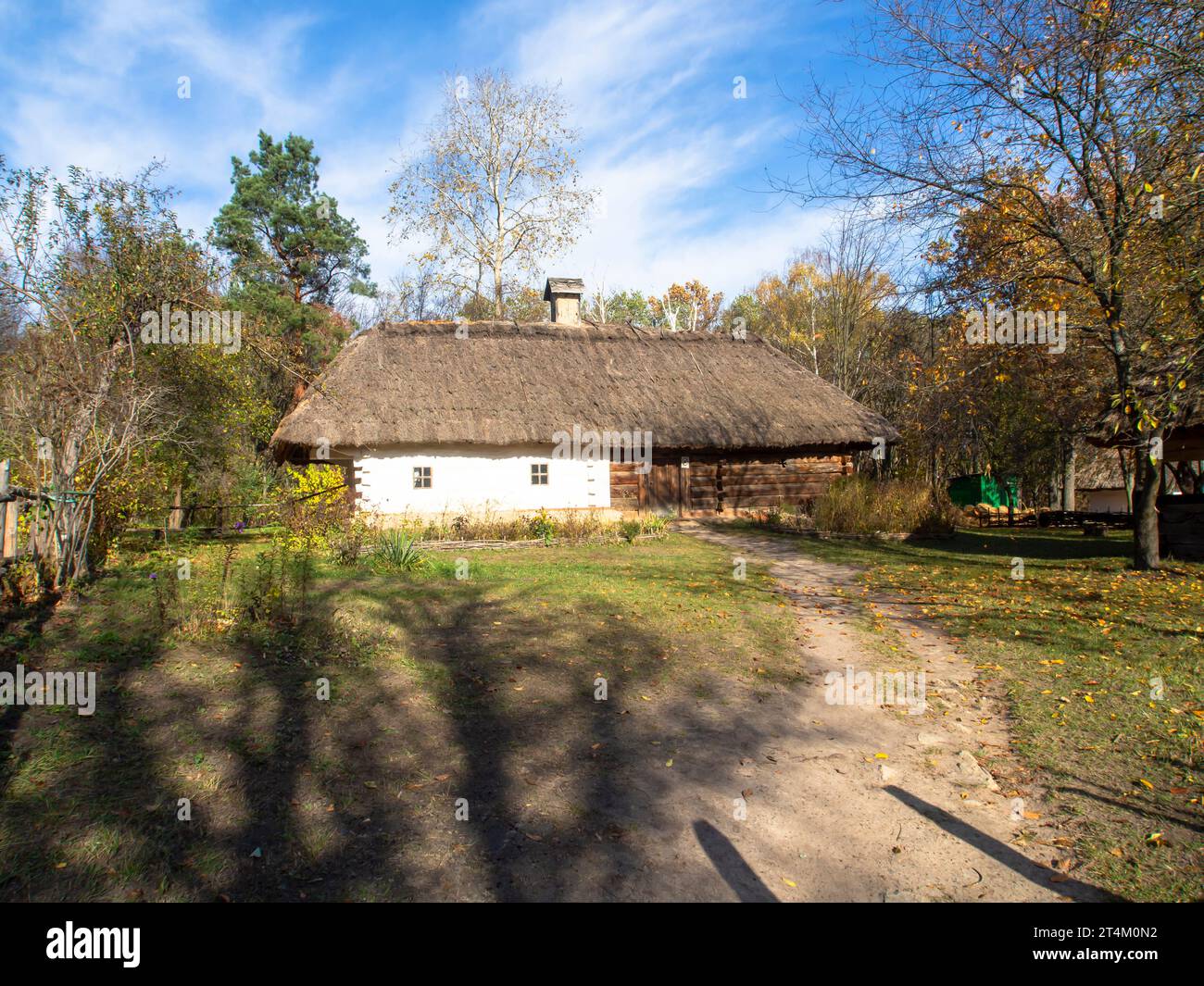 Traditional wooden homes with thatched roof in Ukraine. National Museum ...