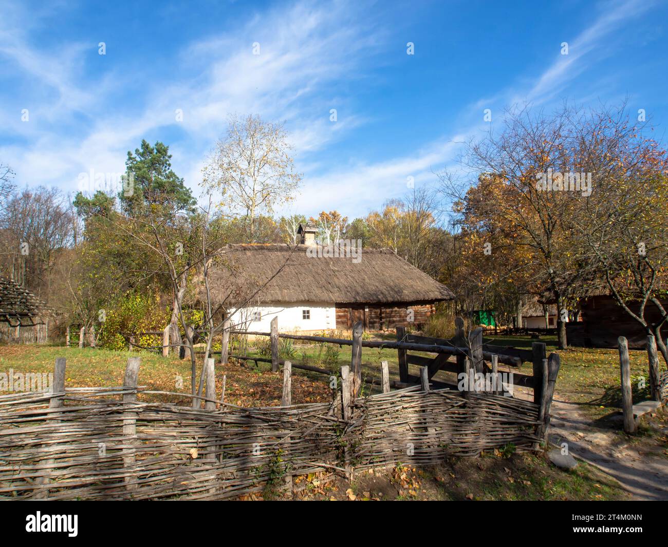 Traditional wooden homes with thatched roof in Ukraine. National Museum ...