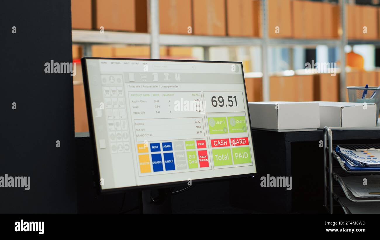 Computer with cash register in empty storage room, multiple cardboard ...
