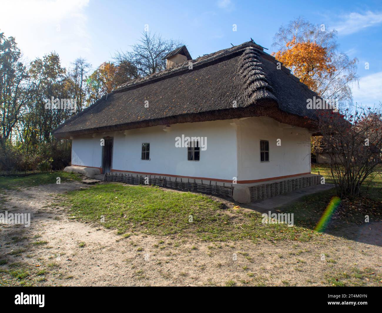 Traditional wooden homes with thatched roof in Ukraine. National Museum ...
