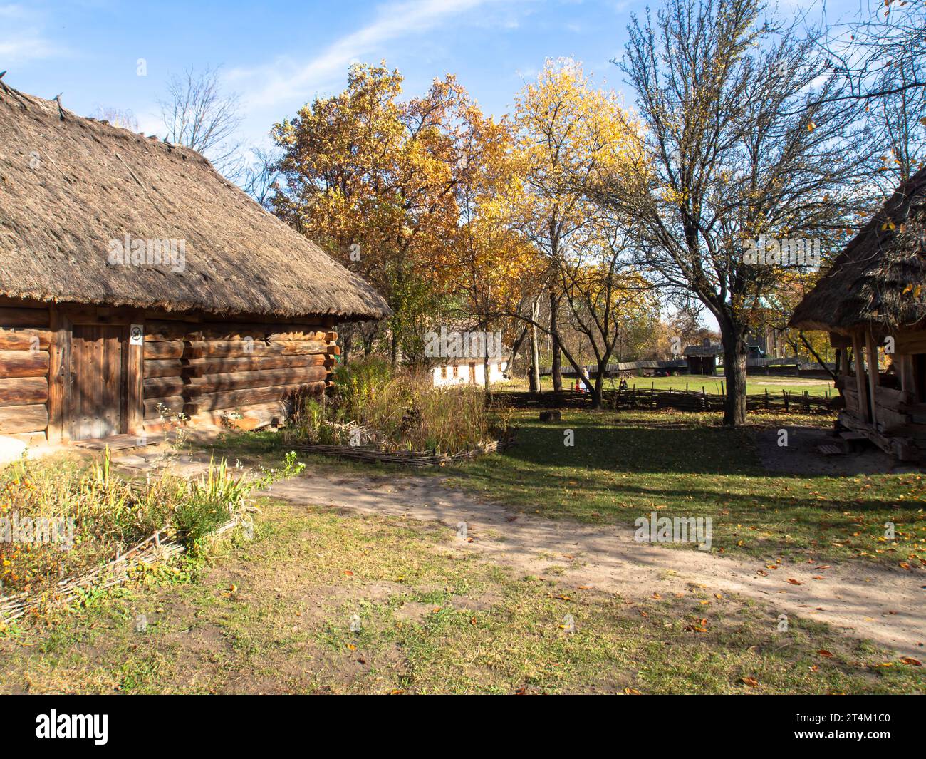 Traditional wooden homes with thatched roof in Ukraine. National Museum ...