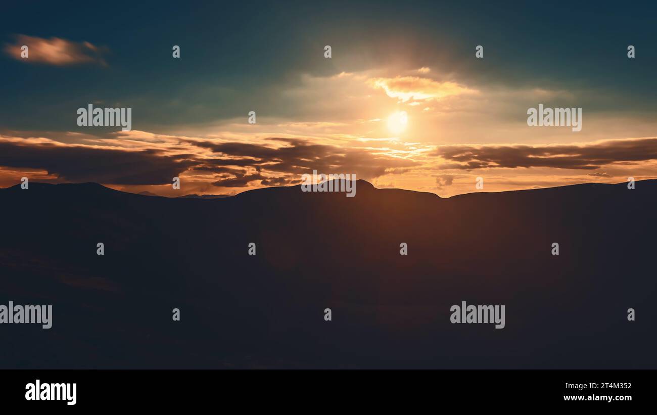 Sunrise cloudscape sky over mountain range silhouette. Dramatic clouds ...