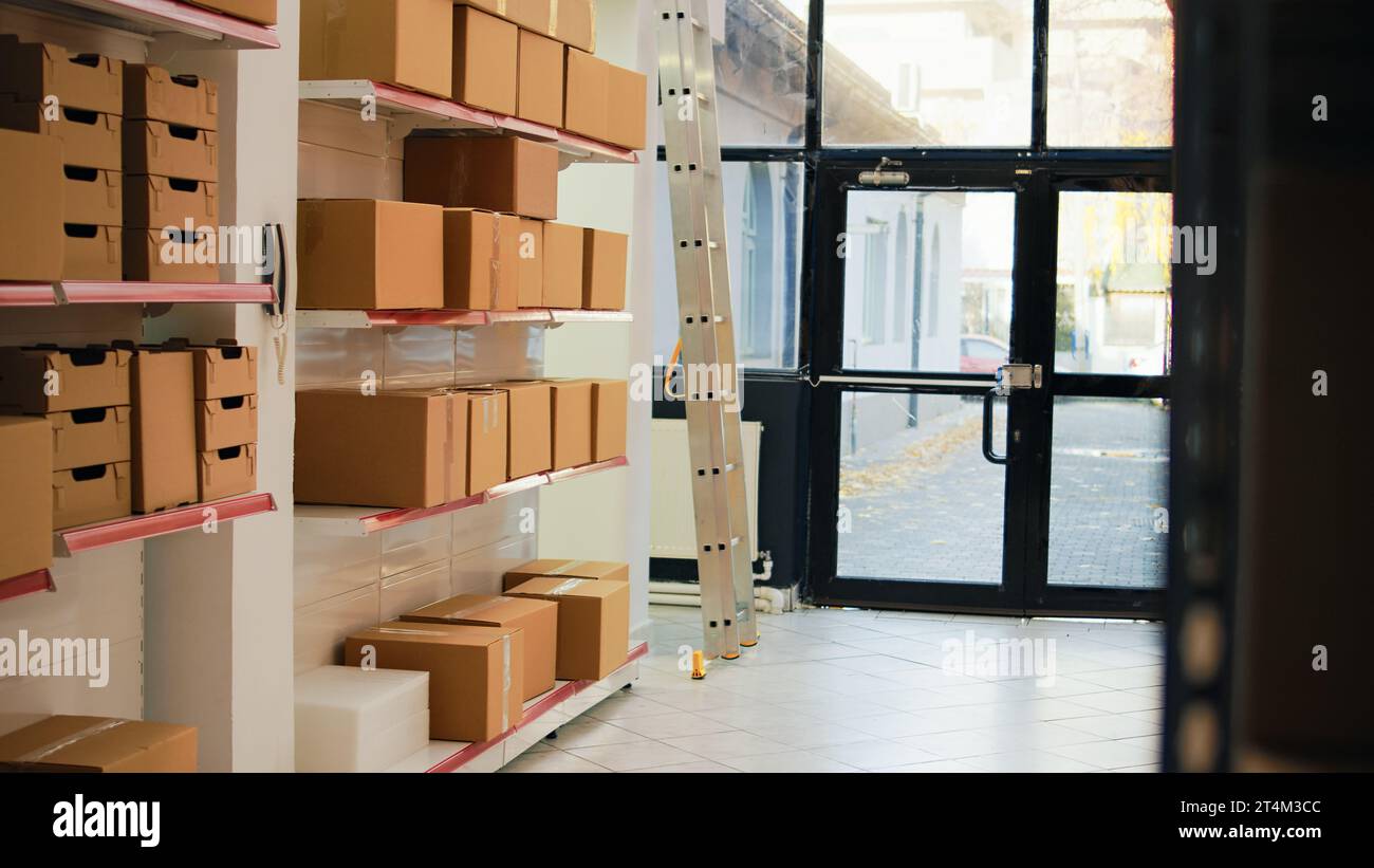 Storage room filled with boxes on racks and shelves, merchandise stock ...