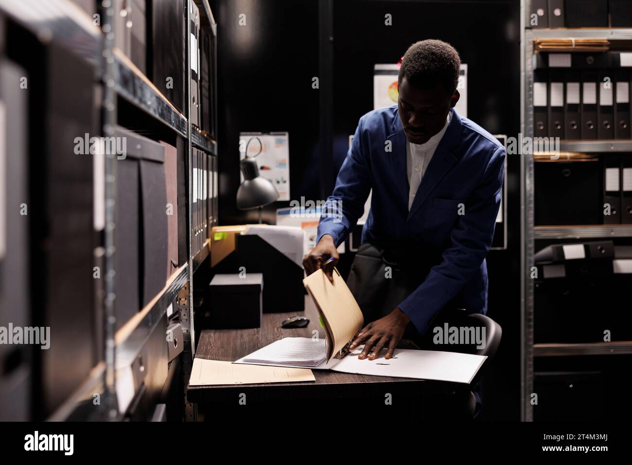 African american manager gathering his stuff, preparing to leave job ...