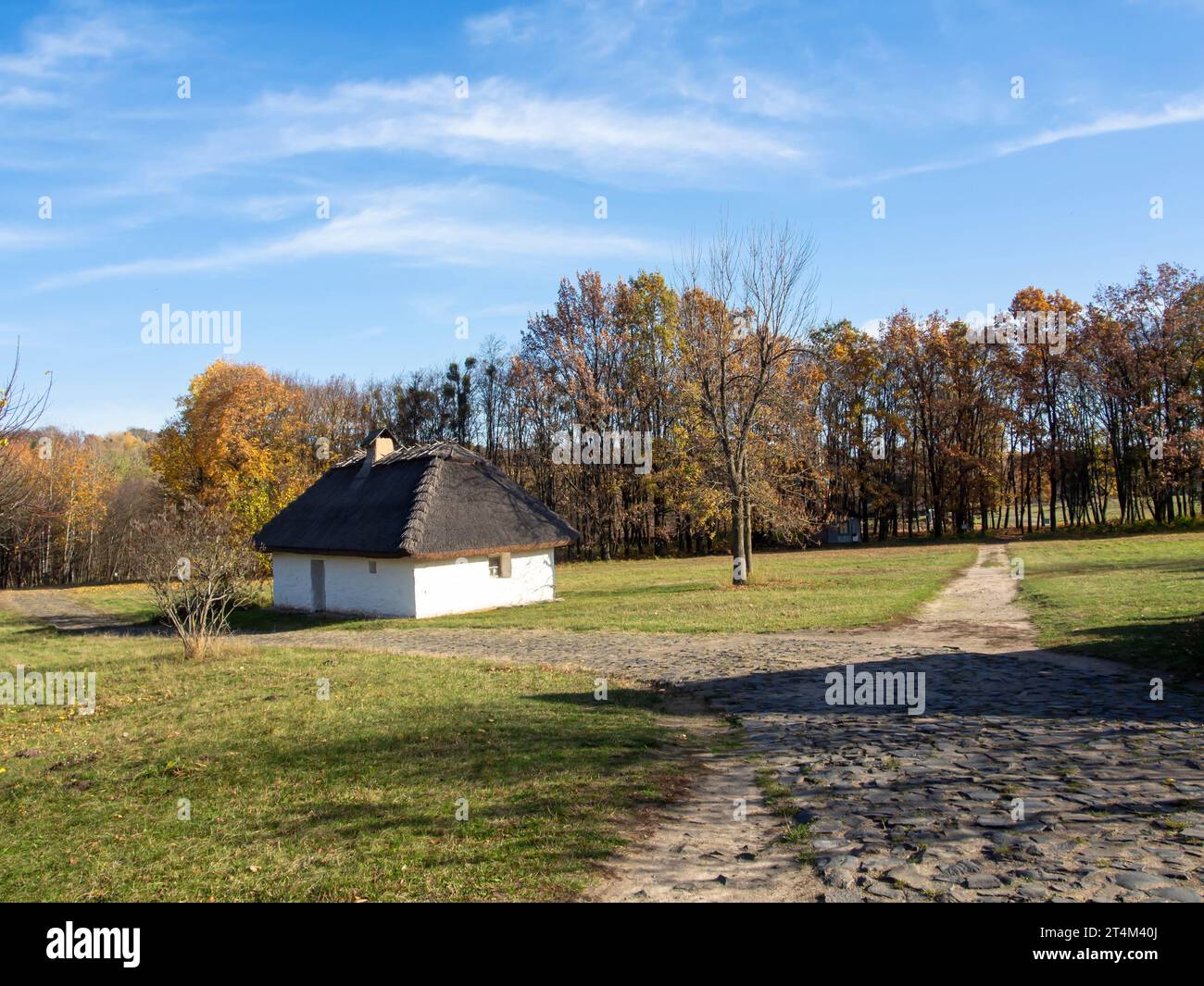 Traditional wooden homes with thatched roof in Ukraine. National Museum ...