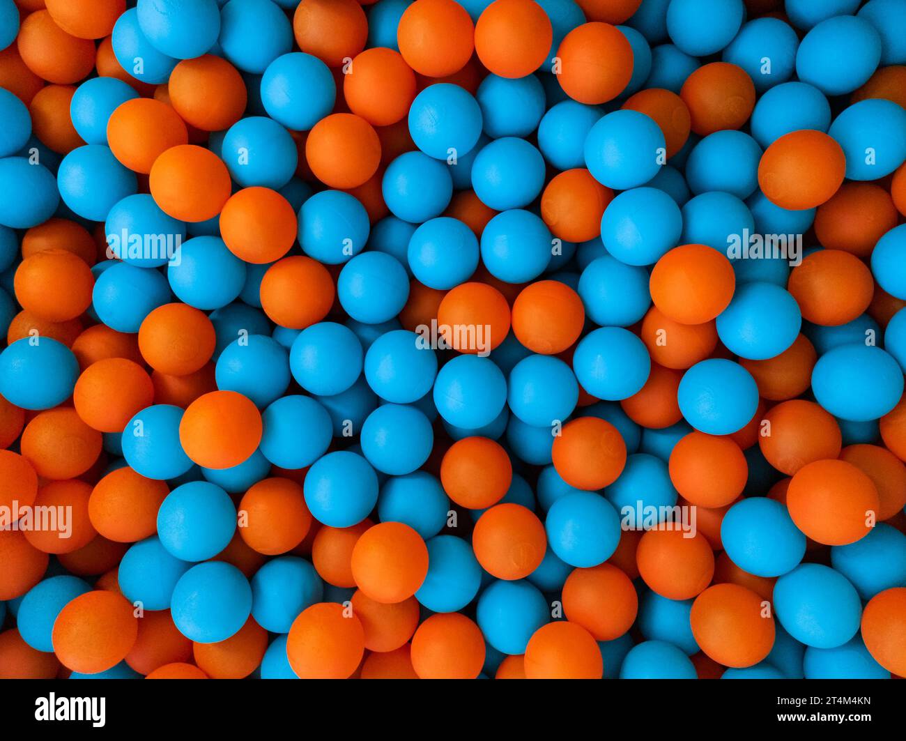 Blue and orange balls in a children's ball pool. Background. Example of ...