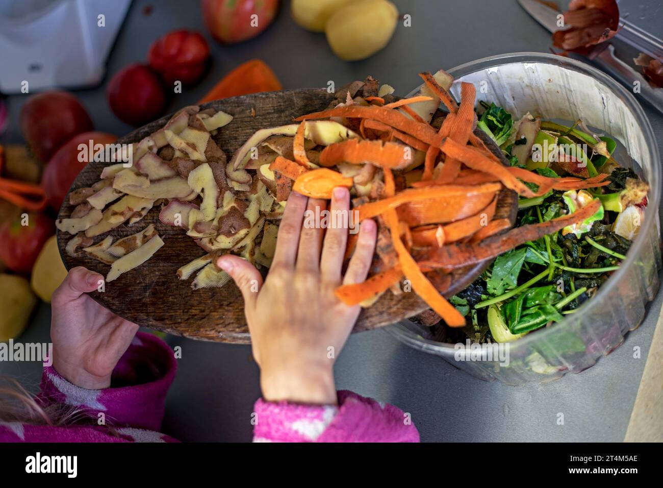 Throw carrot and potato skins into the trash. waste sorting Stock Photo ...