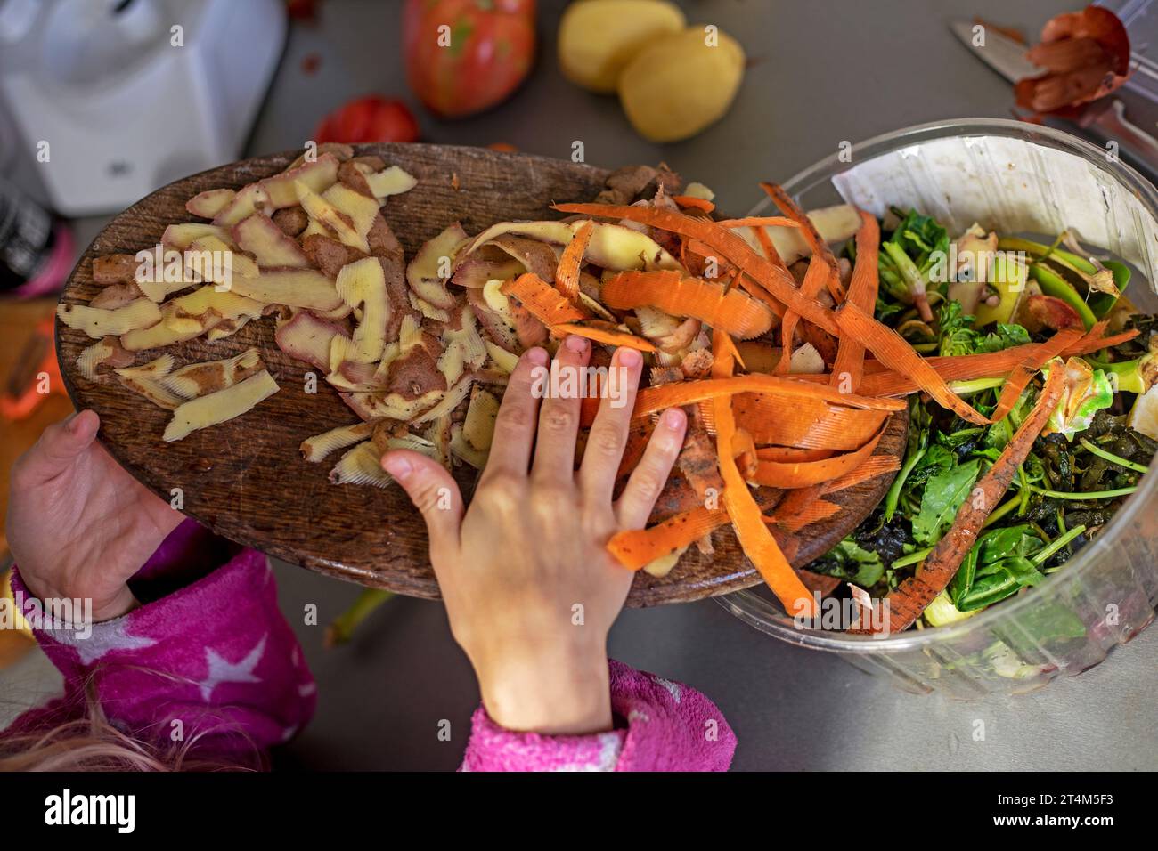 Throw carrot and potato skins into the trash. waste sorting Stock Photo ...