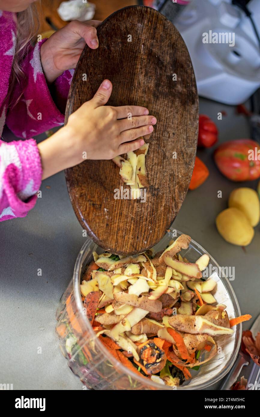 Throw carrot and potato skins into the trash. waste sorting Stock Photo ...