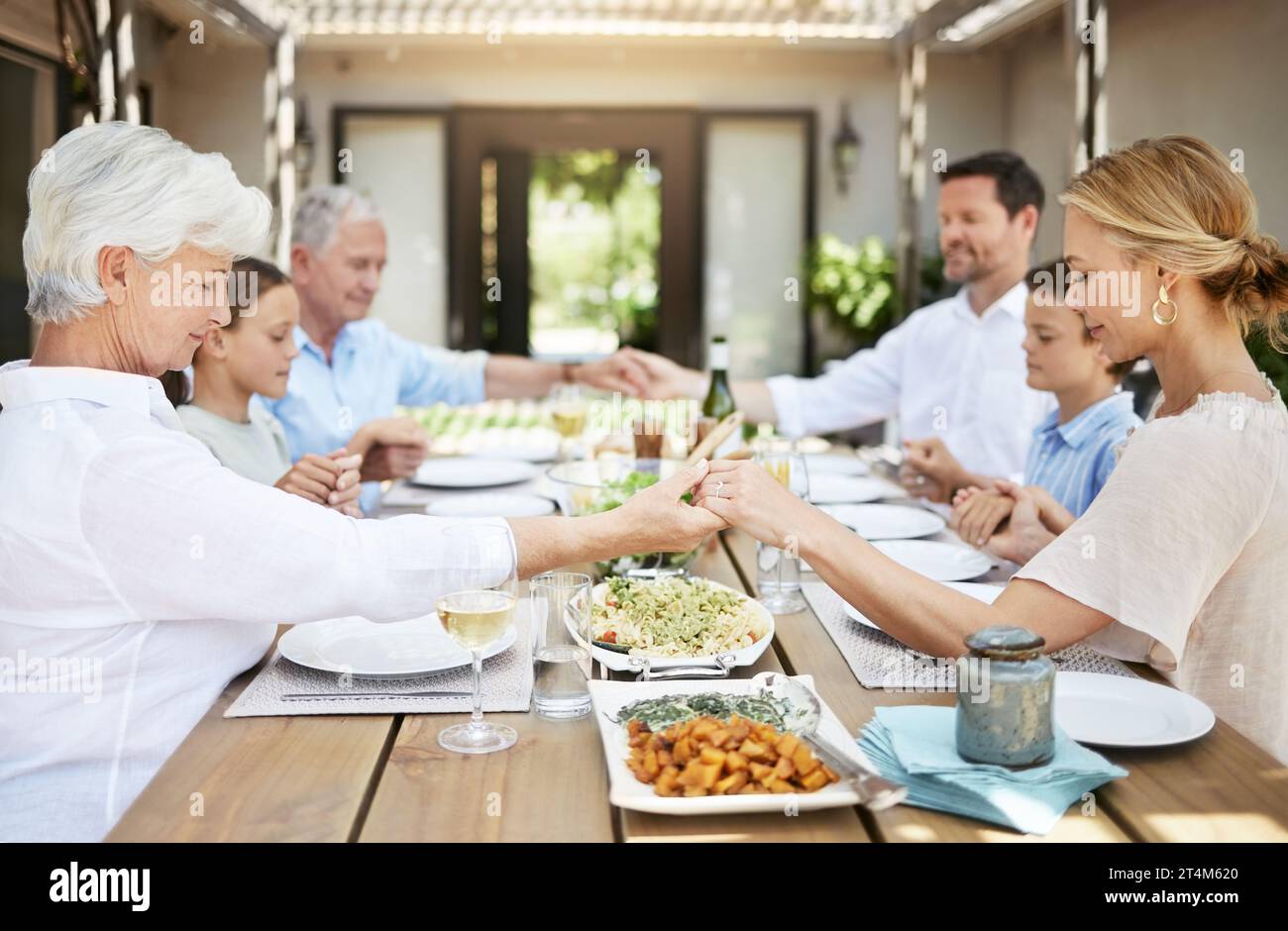 Giving thanks for the food were about to eat. a family saying grace ...