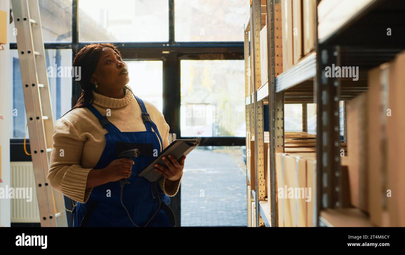 Warehouse employee scanning barcodes on packs, working with scanner and ...