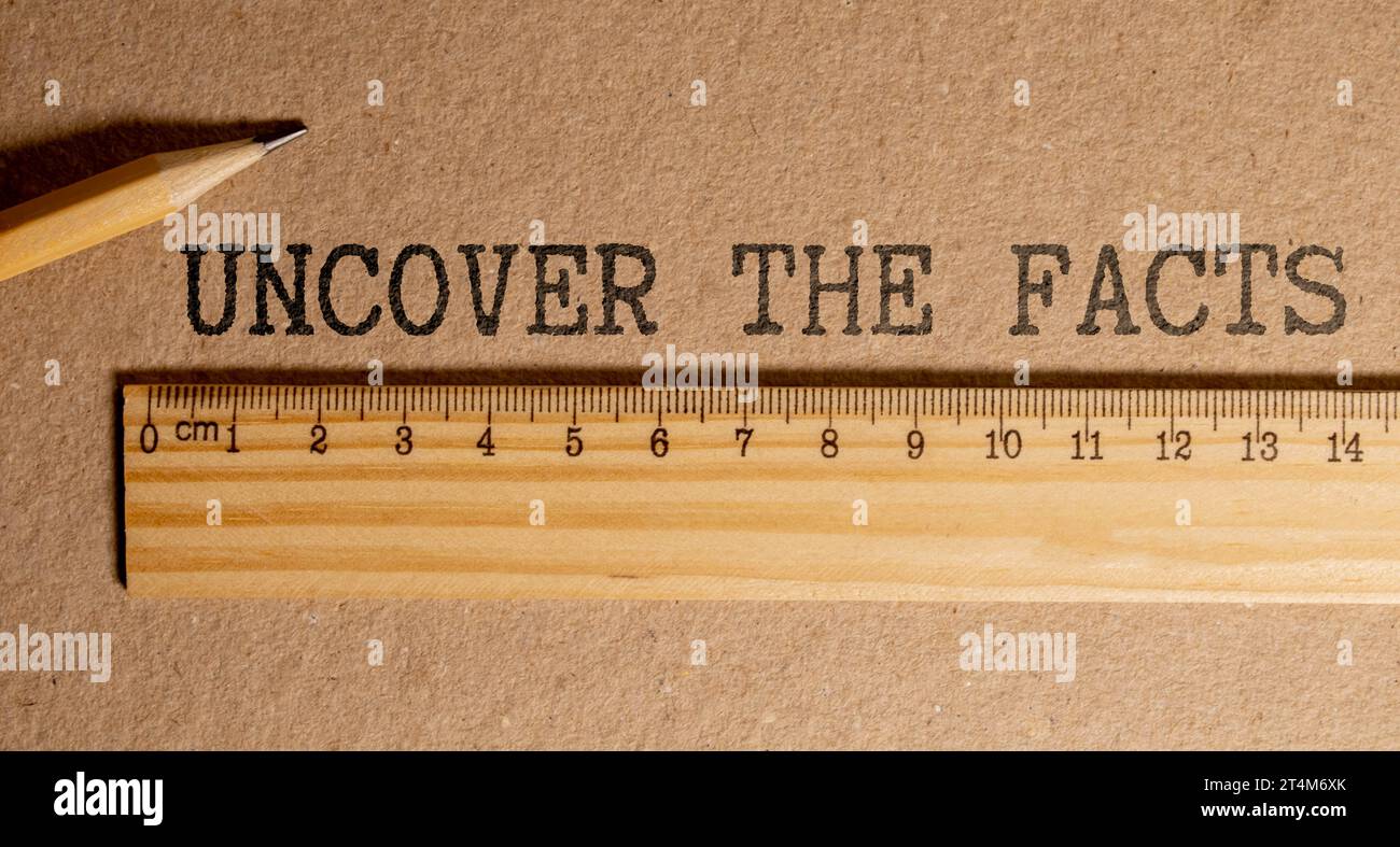 paper with text uncover the facts on white background Stock Photo - Alamy
