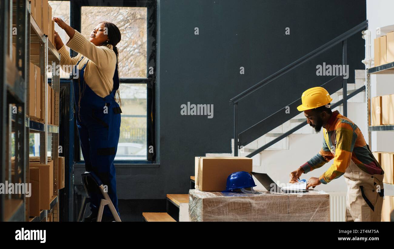 Team warehouse employees taking boxes hi-res stock photography and ...