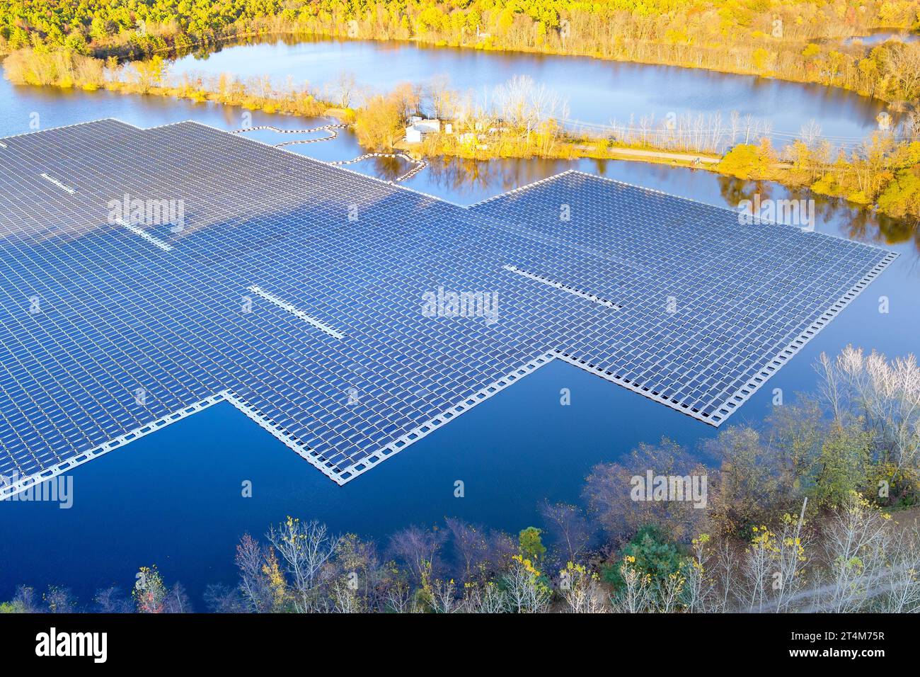 Pond with floating solar panels that generate electricity from sun by ...