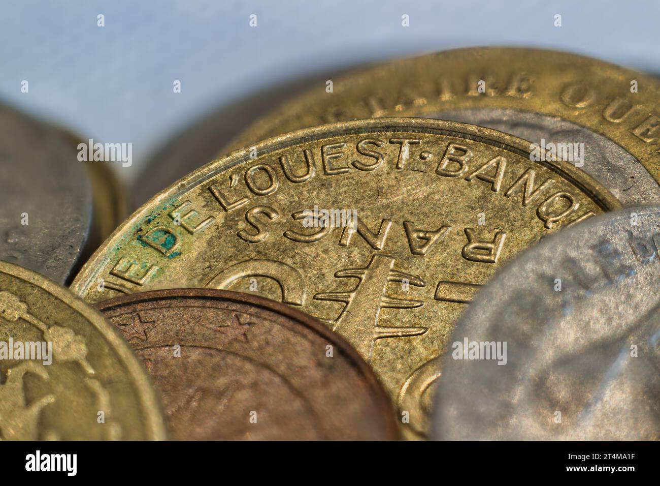 An array of currency coins arranged on a tabletop Stock Photo - Alamy