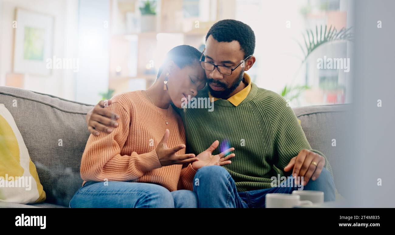 Sad, home and black couple with hug, conversation and emotions with ...